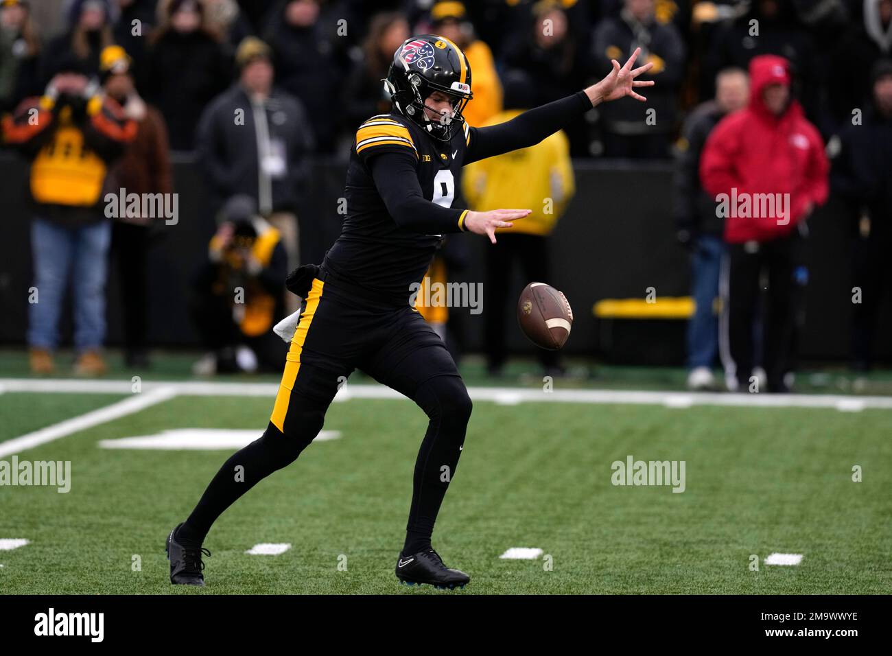 Iowa punter Tory Taylor punts during the first half of an NCAA college ...