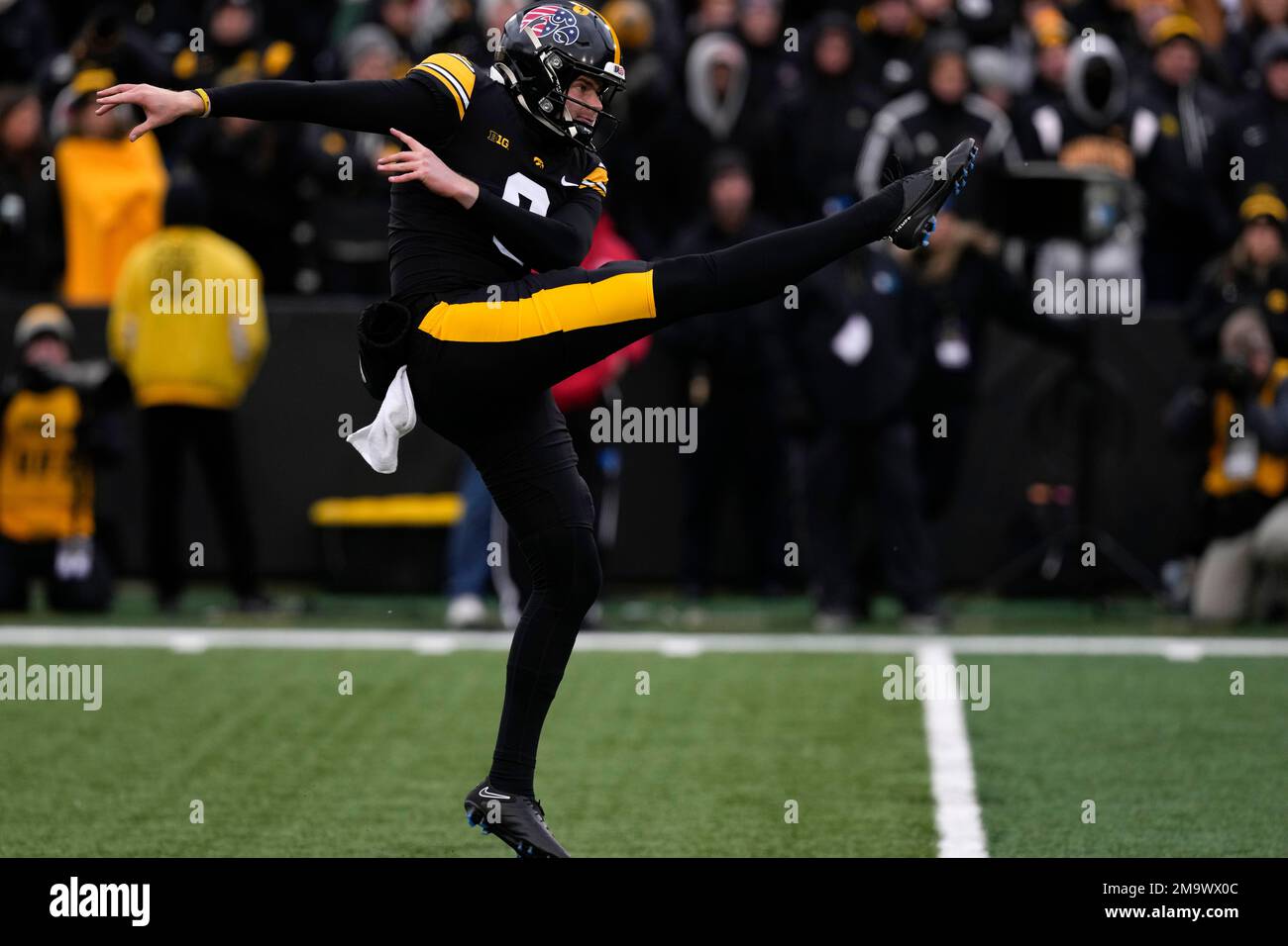 Iowa punter Tory Taylor punts during the first half of an NCAA college ...