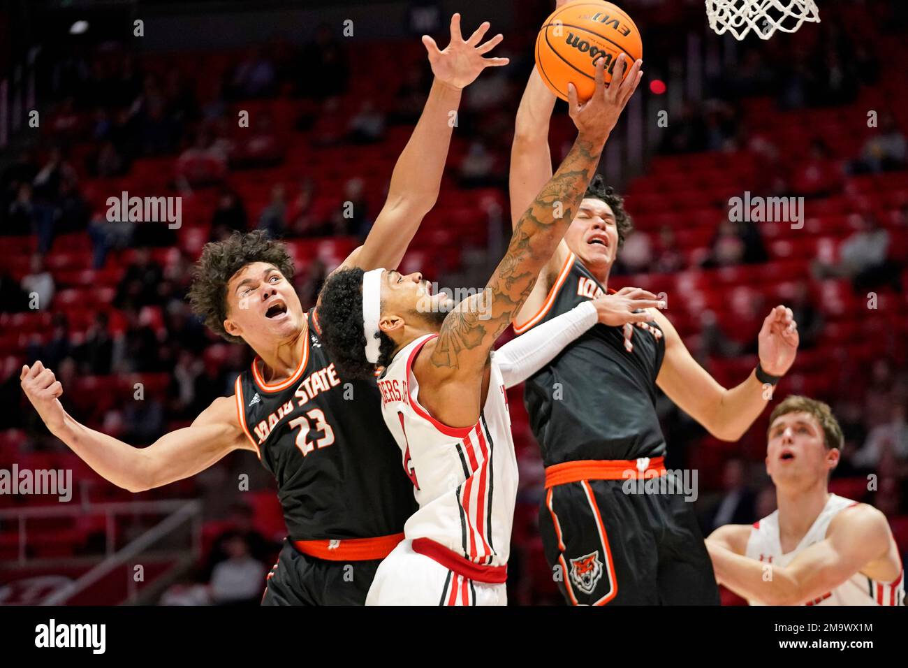 Utah guard Mike Saunders Jr., center, goes to the basket as Idaho State ...