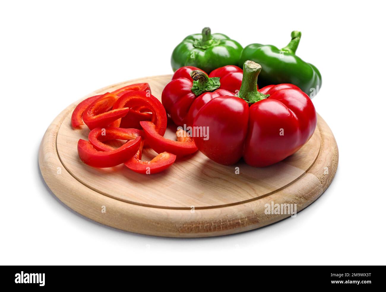 Wooden board with bell peppers on white background Stock Photo - Alamy