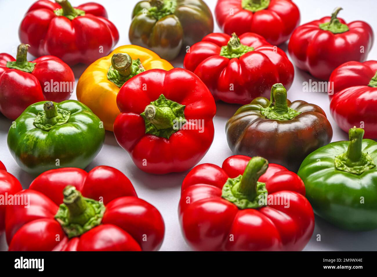 Many fresh bell peppers on white background Stock Photo - Alamy