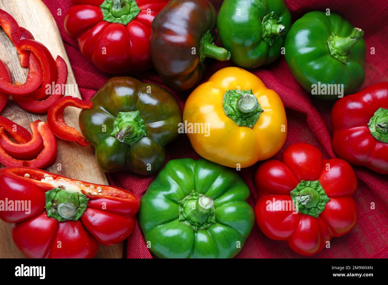 Different bell peppers on fabric background Stock Photo - Alamy