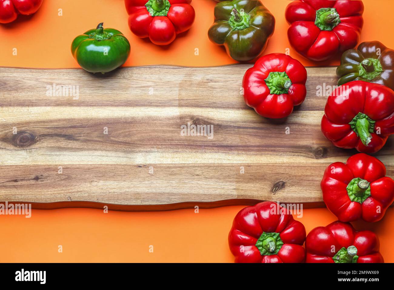 Composition with fresh bell peppers and wooden board on color ...