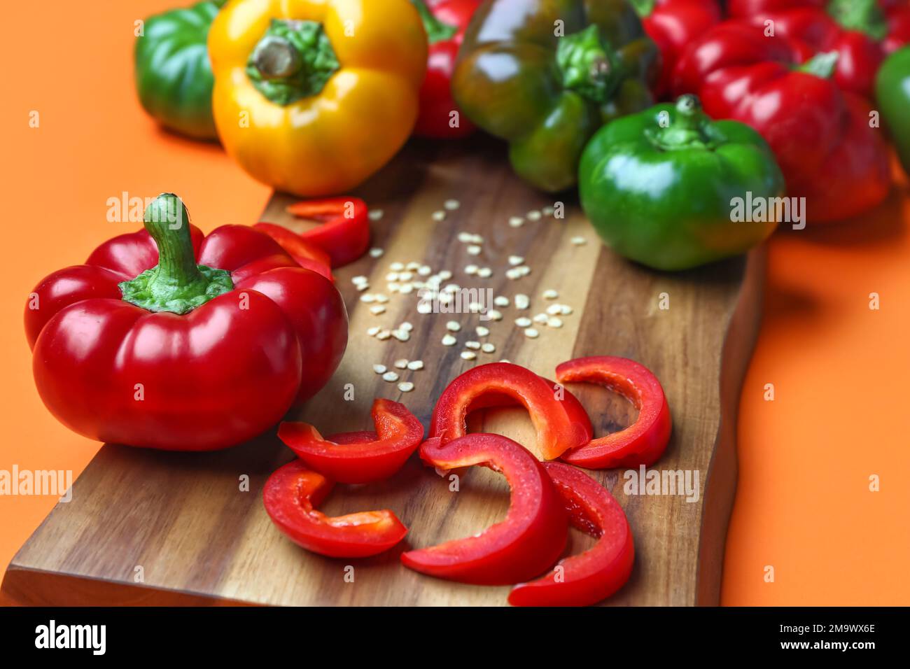 Wooden board of fresh bell peppers on color background, closeup Stock ...