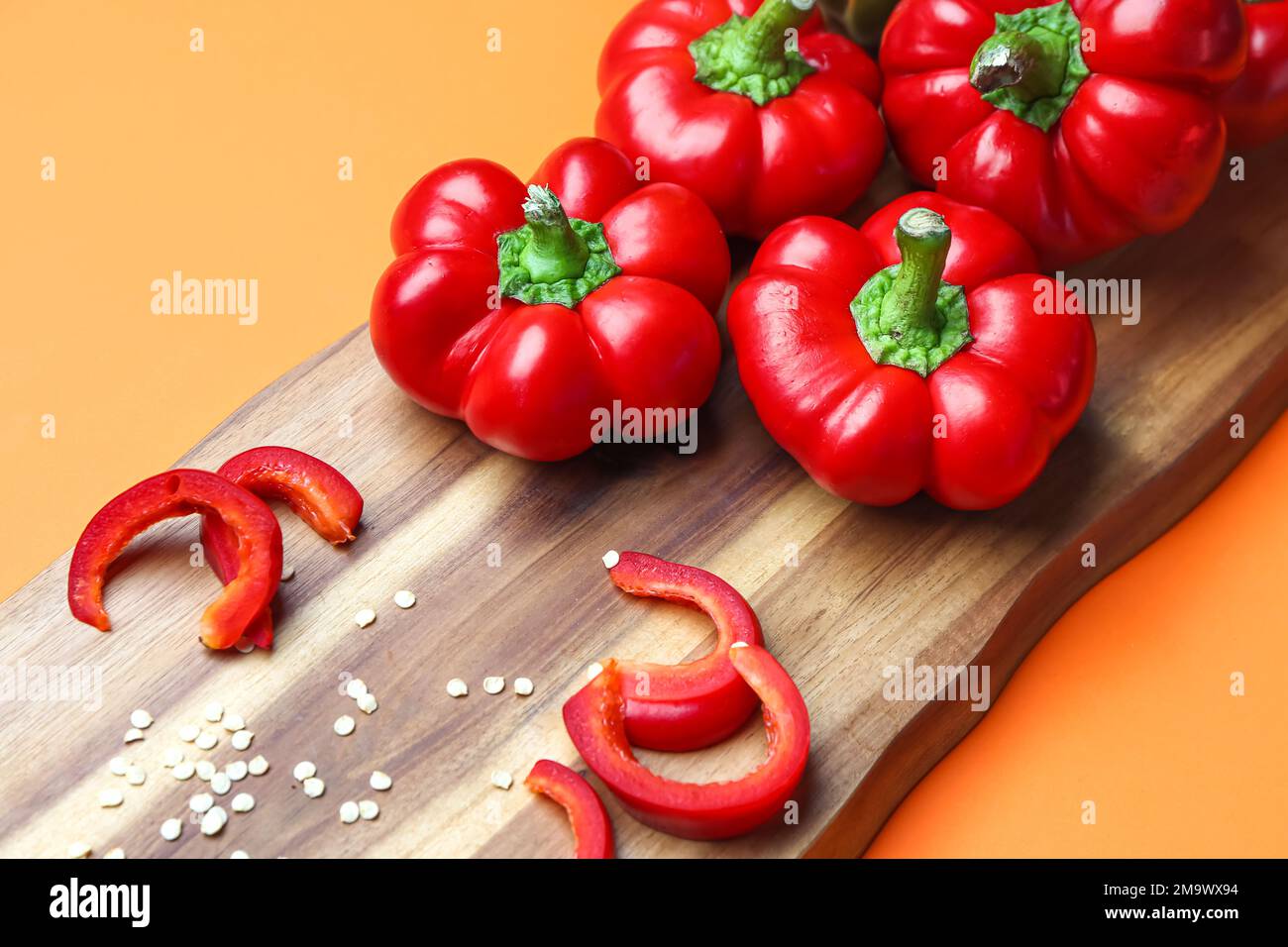 Wooden board of fresh bell peppers on color background, closeup Stock ...