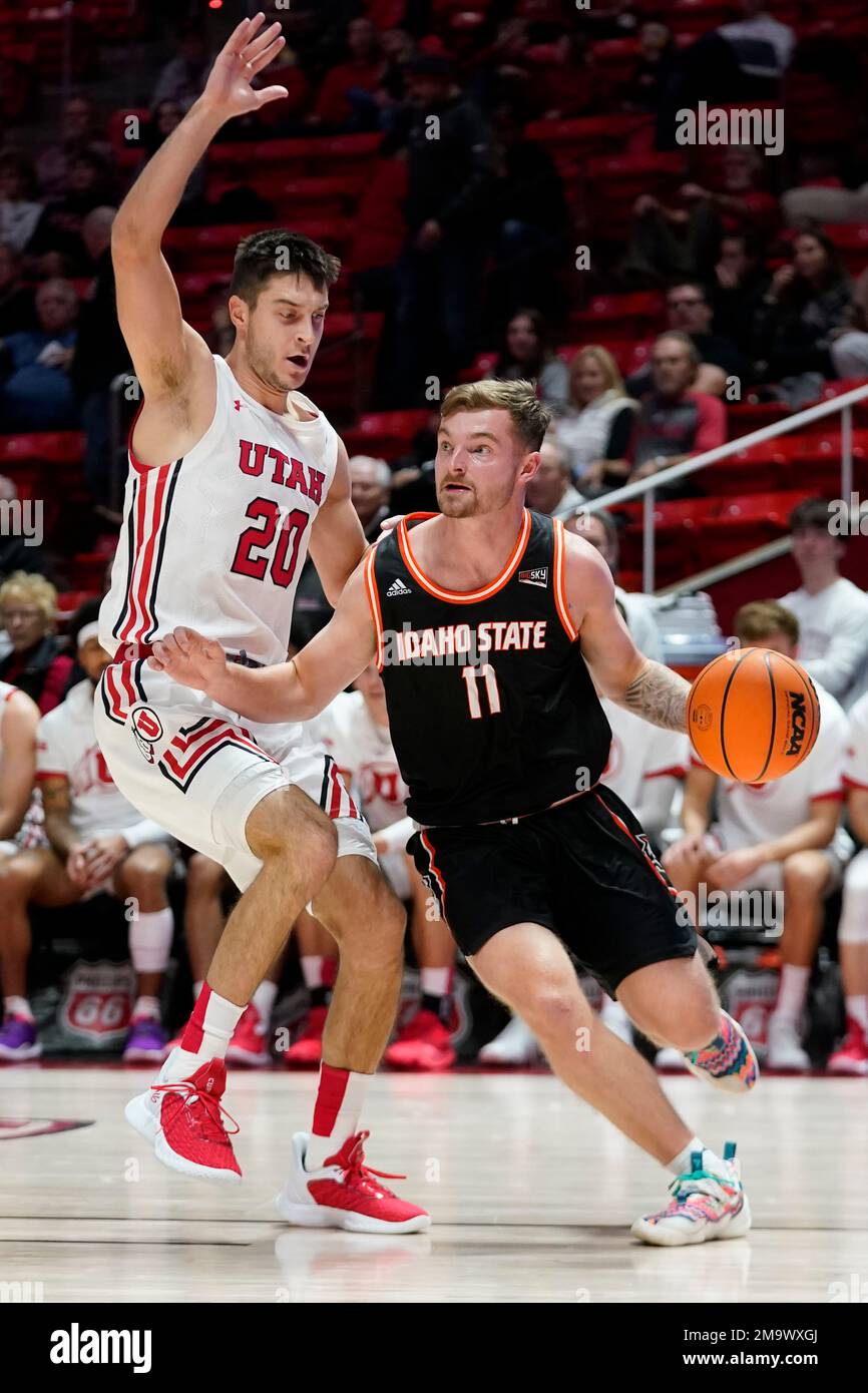 Idaho State guard Brock Mackenzie (11) drives around Utah guard Lazar ...