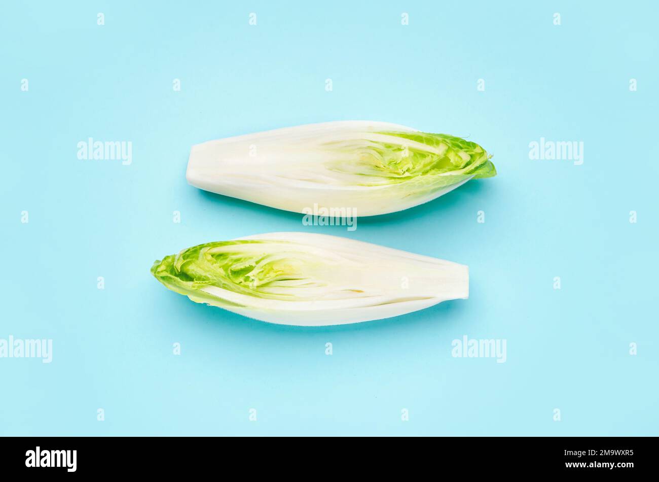 Cut bunch of fresh endive on color background Stock Photo - Alamy