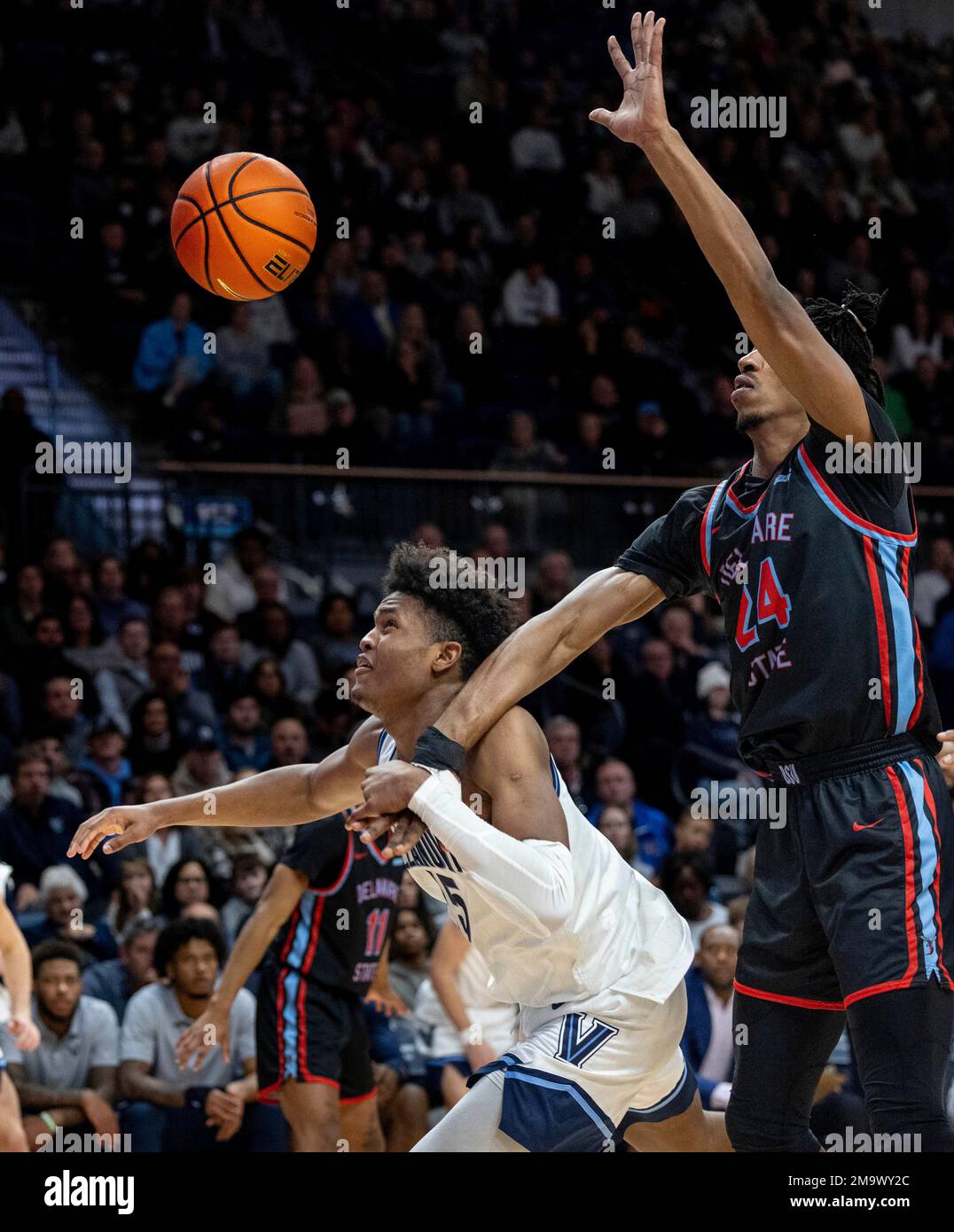 Villanova guard Jordan Longino, left, is fouled by Delaware State ...
