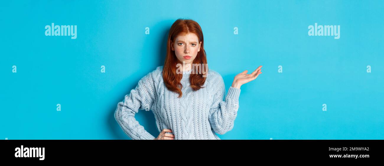 Skeptical teenage girl looking unamused, raising hand in so what ...