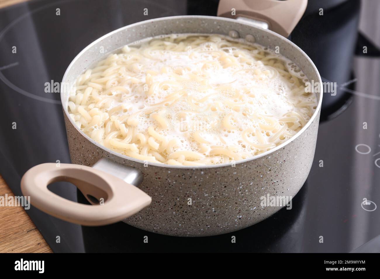 Cooking pot with boiling pasta on stove, closeup Stock Photo - Alamy