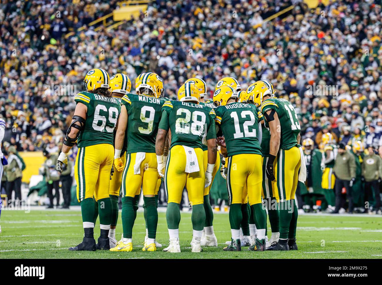 Green Bay Packers huddle against the Dallas Cowboys during an NFL ...