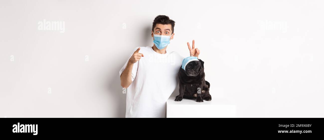 Covid-19, animals and quarantine concept. Happy dog owner and cute pug ...