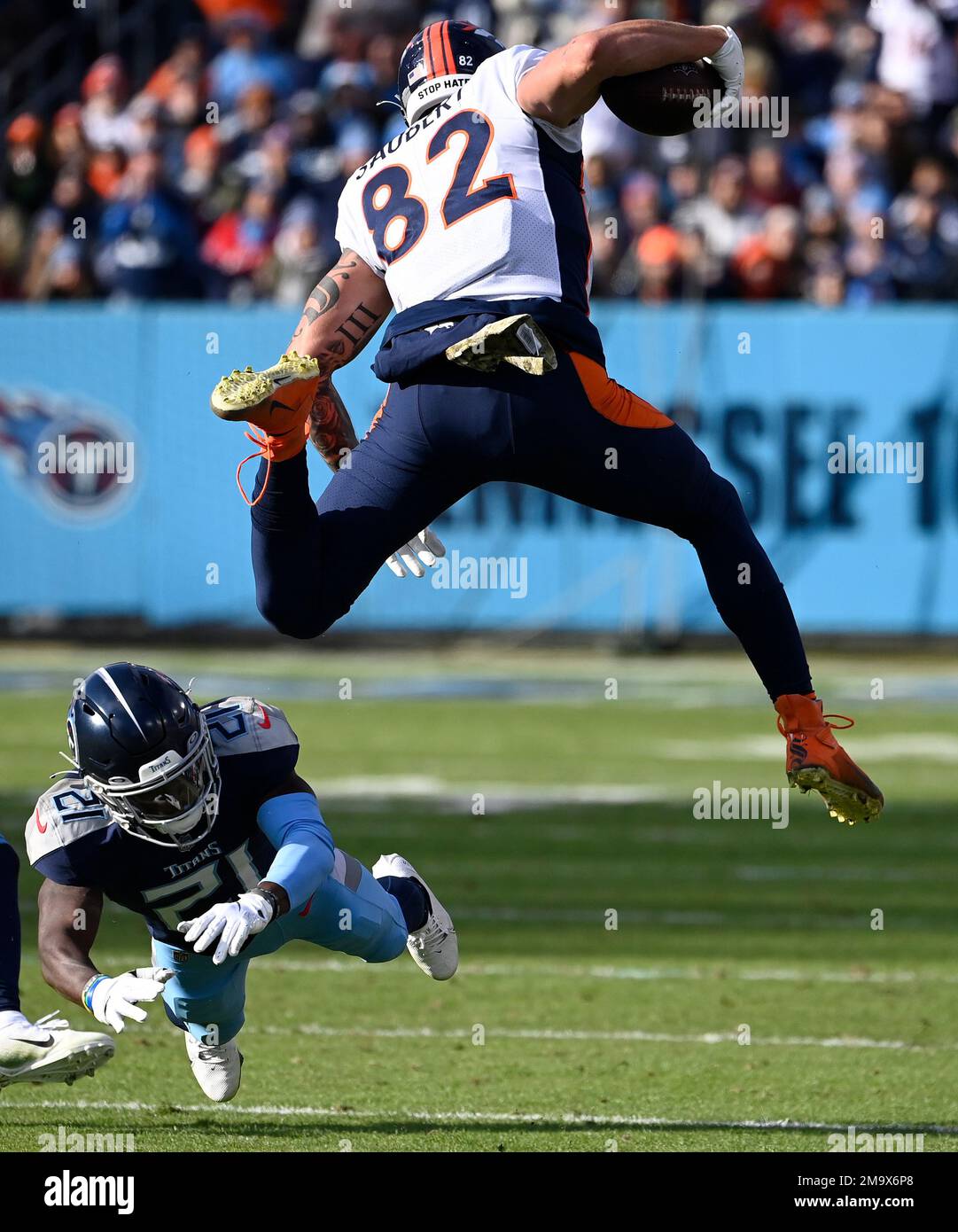 Denver Broncos tight end Eric Saubert (82) leaps over Tennessee Titans ...