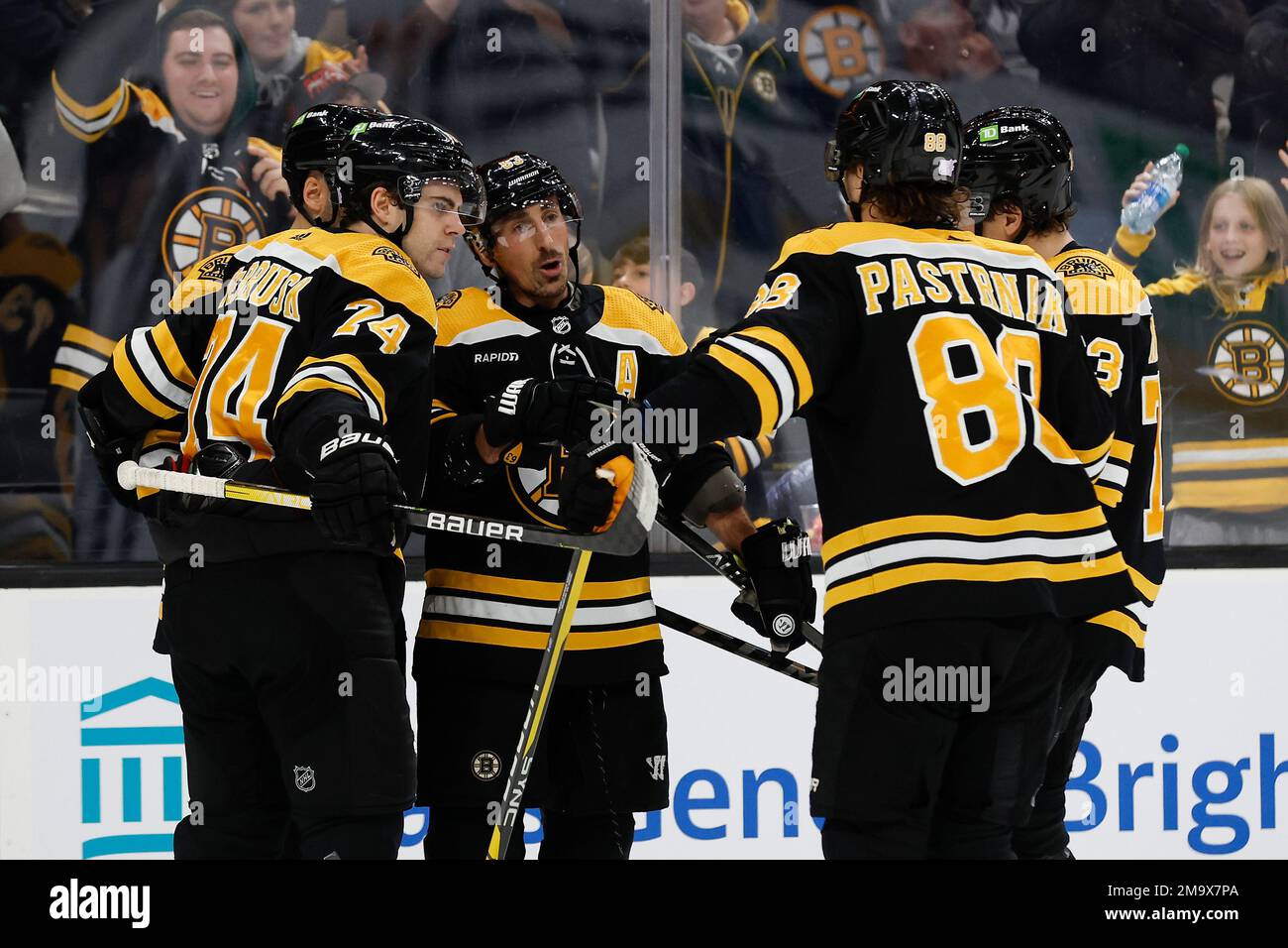 Boston Bruins' Brad Marchand, center, is congratulated by Jake DeBrusk ...