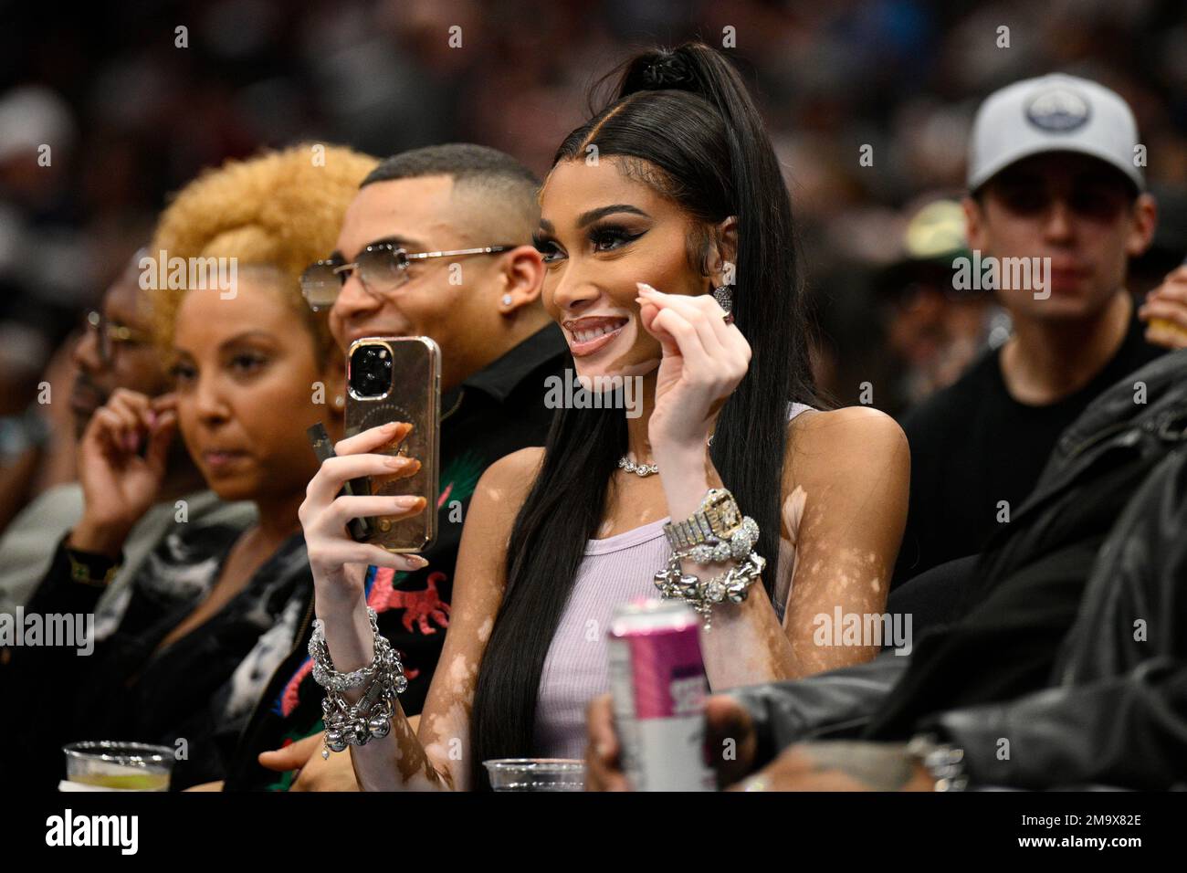 Fashion model Winnie Harlow watches during the second half of an NBA ...