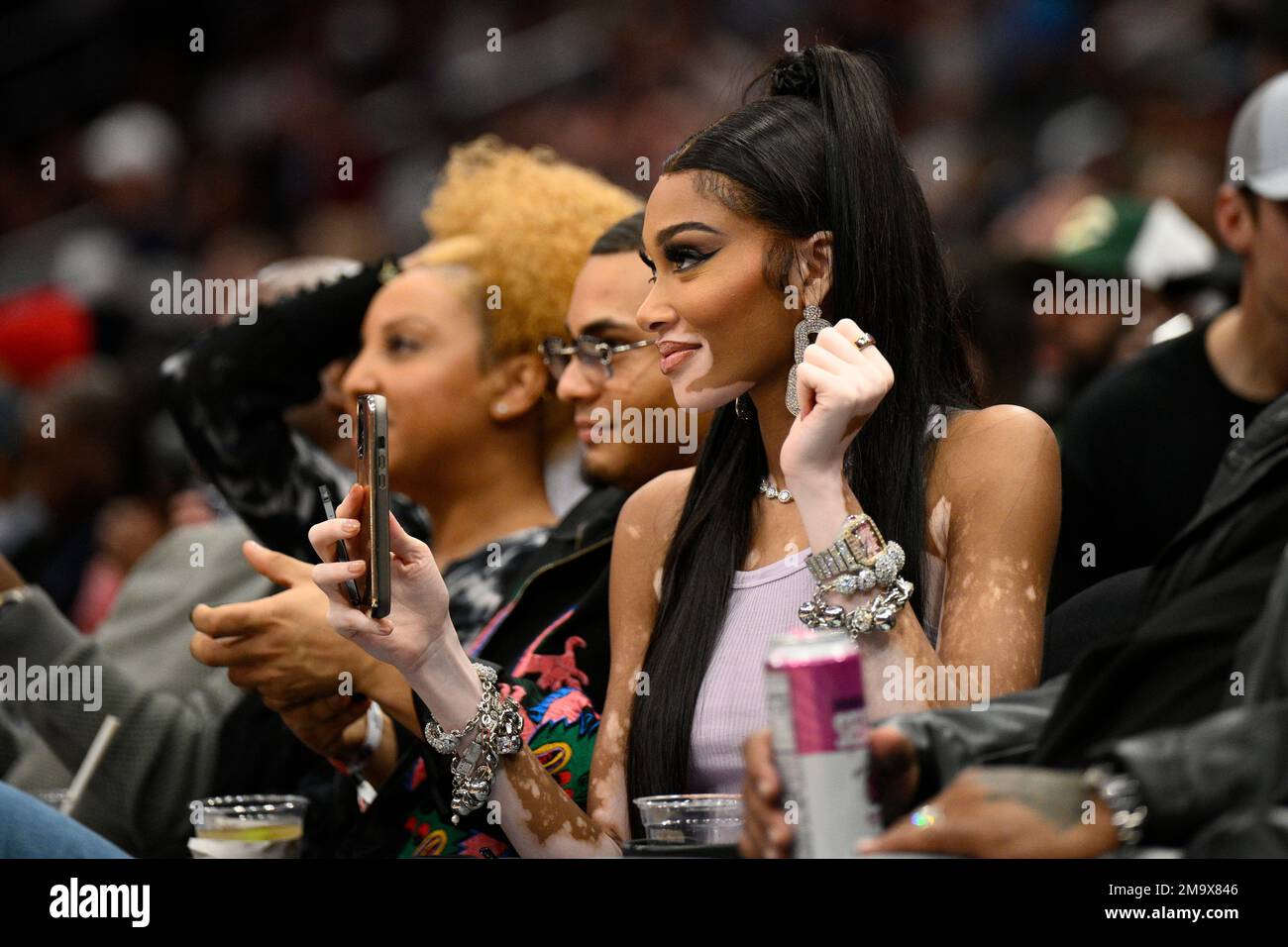 Fashion model Winnie Harlow watches during the second half of an NBA ...