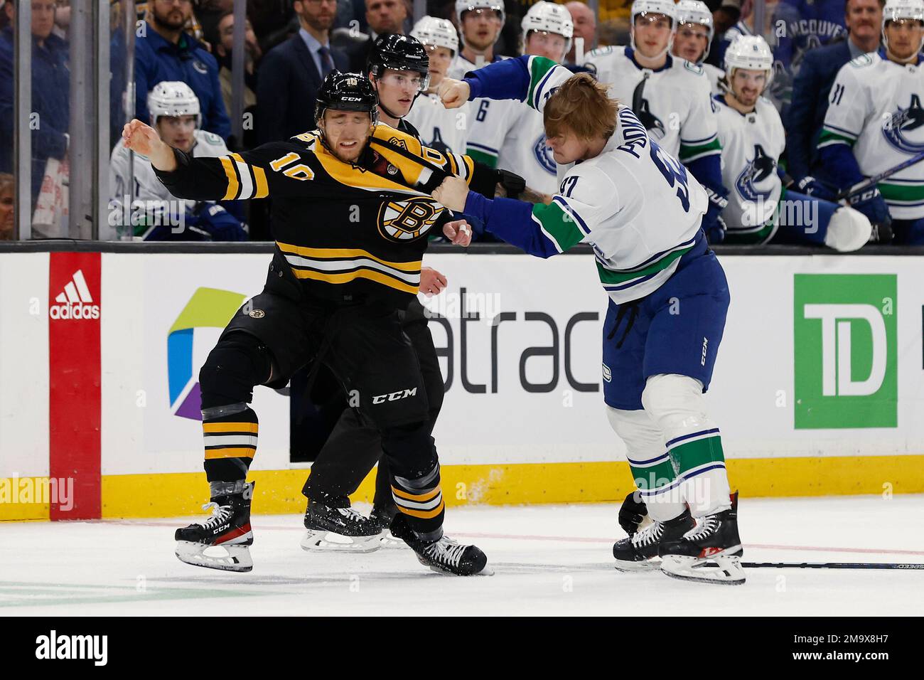 Boston Bruins' A.J. Greer (10) fights with Vancouver Canucks' Vasily Podkolzin during the first ...