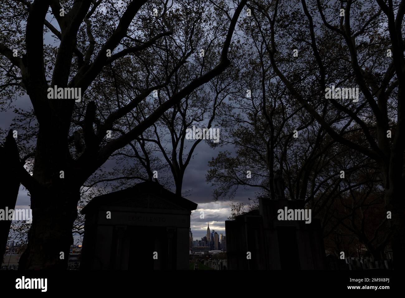 The sun sets behind the New York skyline, Sunday, Nov. 13, 2022, as ...