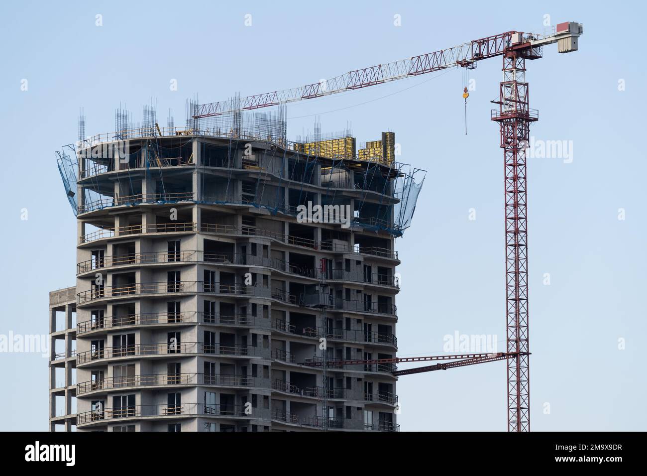 Multi-storey residential building with tower crane during construction ...