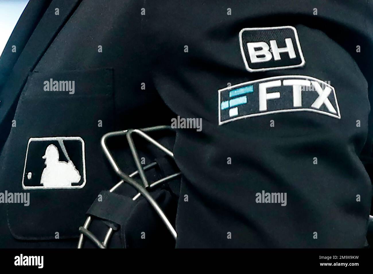 FILE - The FTX logo appears on a home plate umpire's jacket at a ...