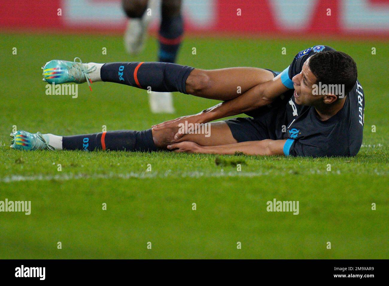 Marseille's Amine Harit lies on the pitch in pain during the French ...