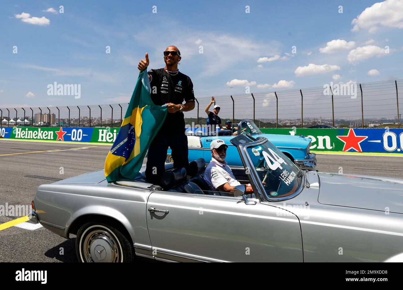 Mercedes driver Lewis Hamilton, of Britain, holds a Brazil national ...
