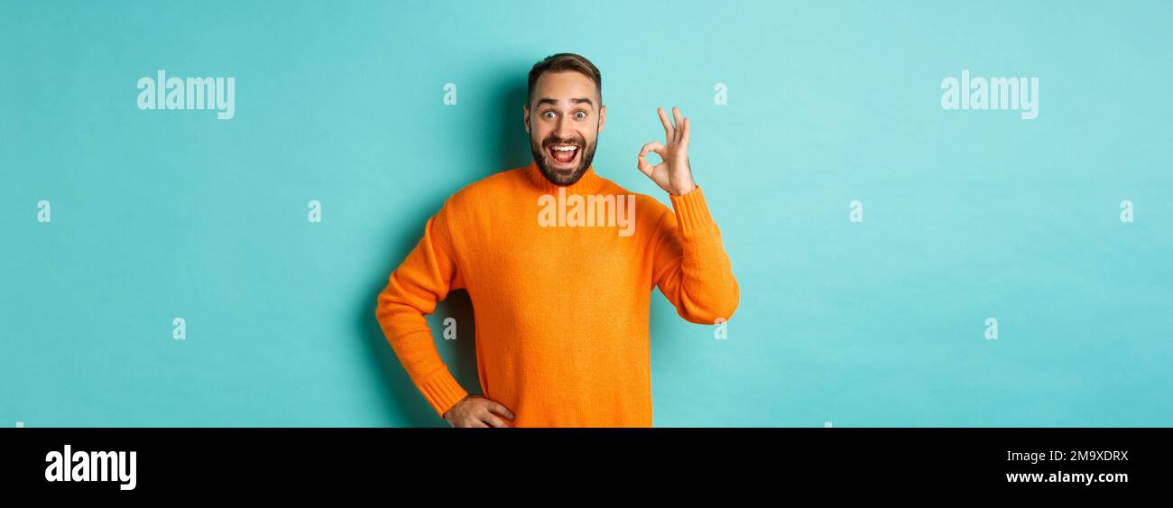 Impressed man recommending promo, showing okay sign and smiling amazed ...