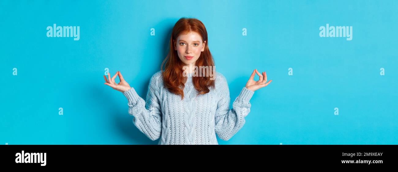 Smiling confident girl with red hair staying patient, holding hands in ...