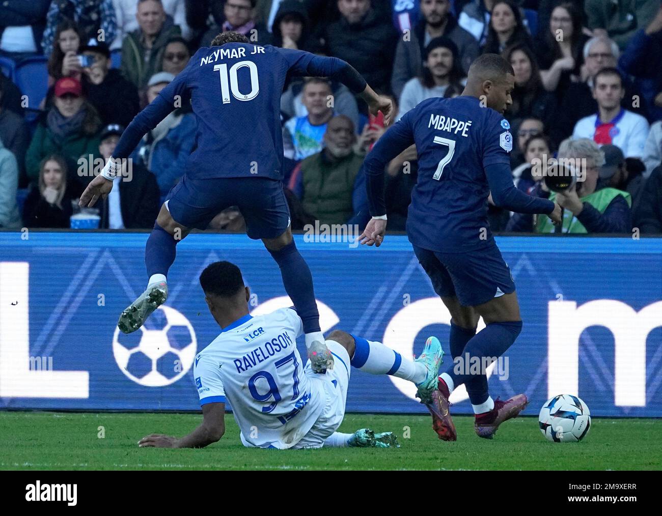 Auxerre's Rayan Raveloson, bottom, challenges for the ball with PSG's ...