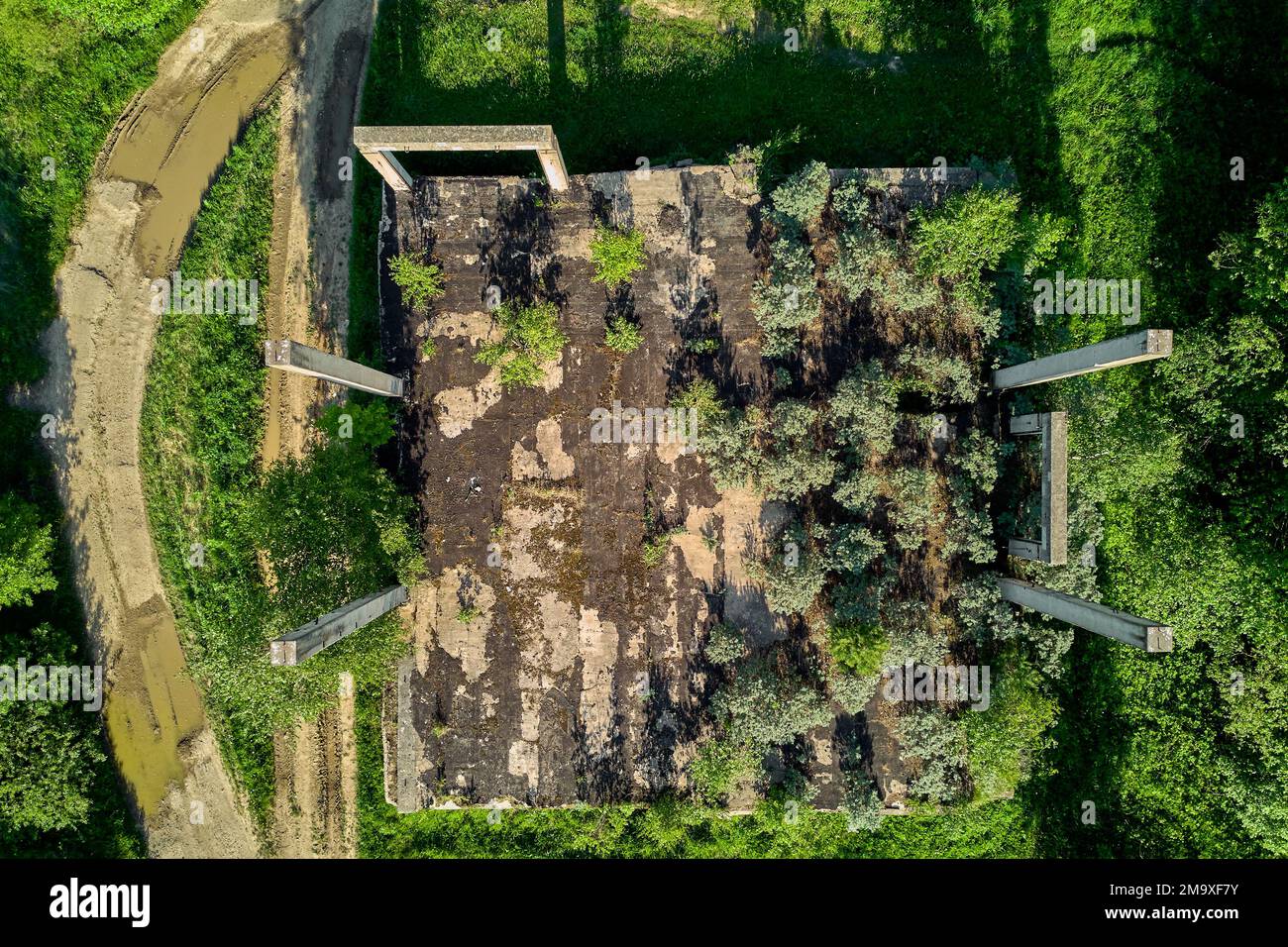 Aerial view of an abandoned building in the middle of nature overgrown ...