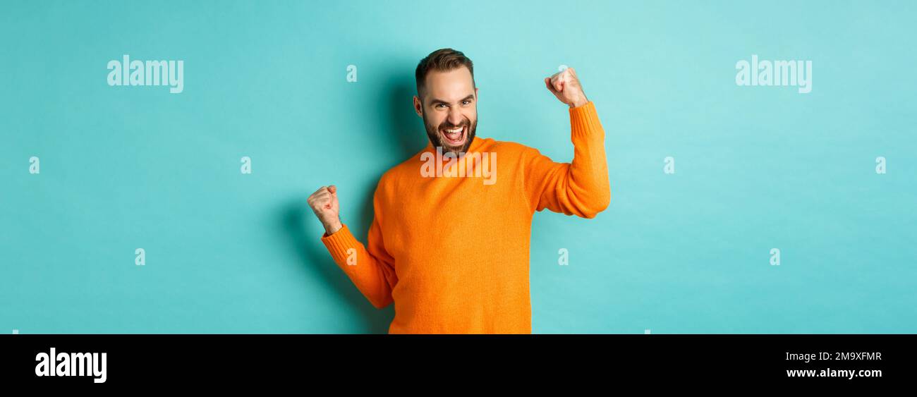 Winner. Excited man triumphing, making fist pump and saying yes ...