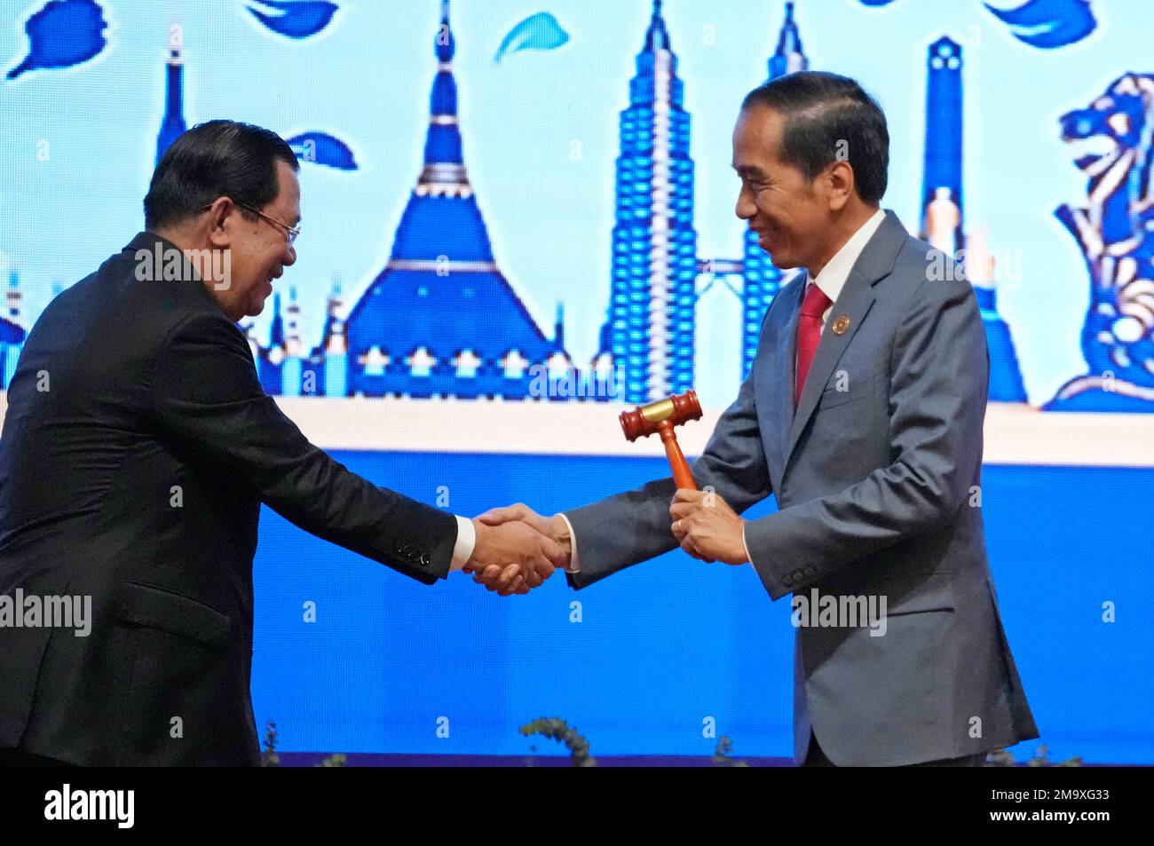 Cambodian Prime Minister Hun Sen, left, hands over the gavel to ...