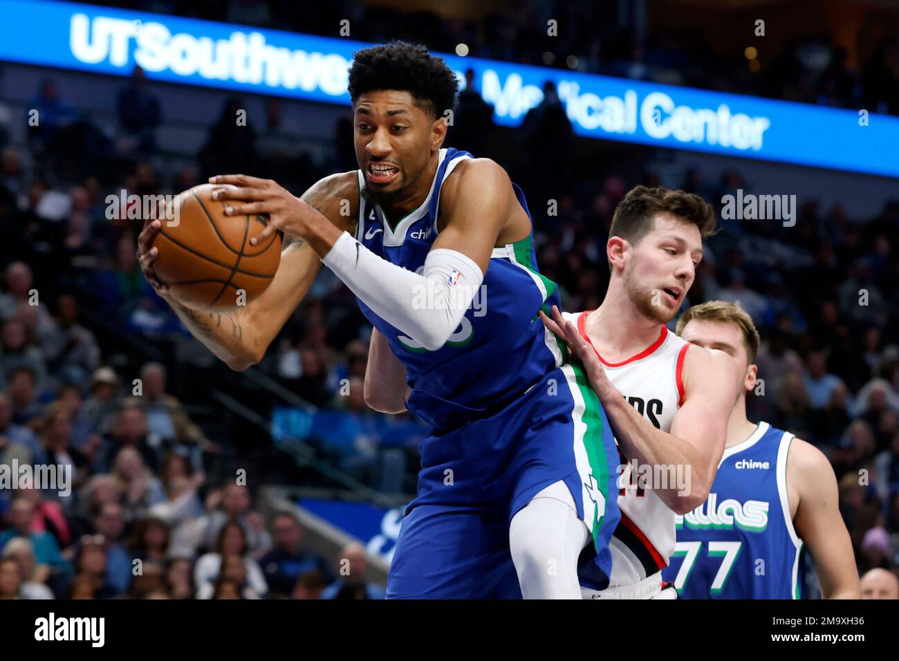 Dallas Mavericks center Christian Wood grabs a rebound in front of ...
