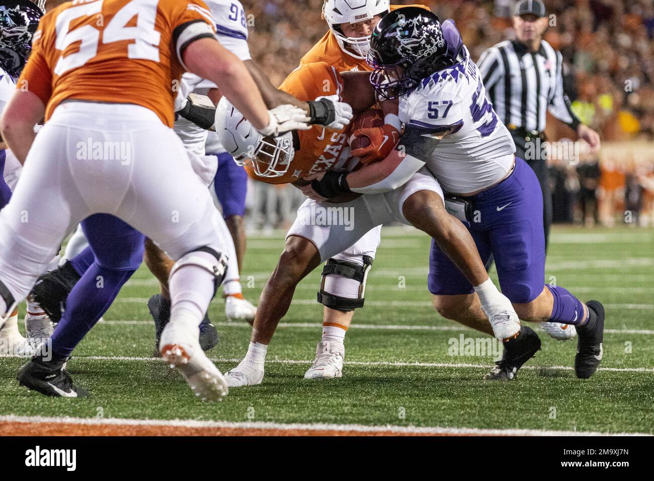 TCU linebacker Johnny Hodges (57) tackles Texas running back Bijan ...