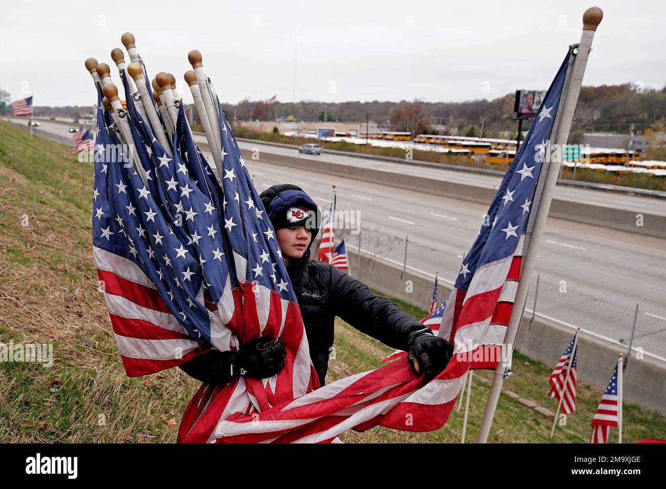 Volunteer worker Wesley Dubrevil, 16, gathers flags that were part of a ...