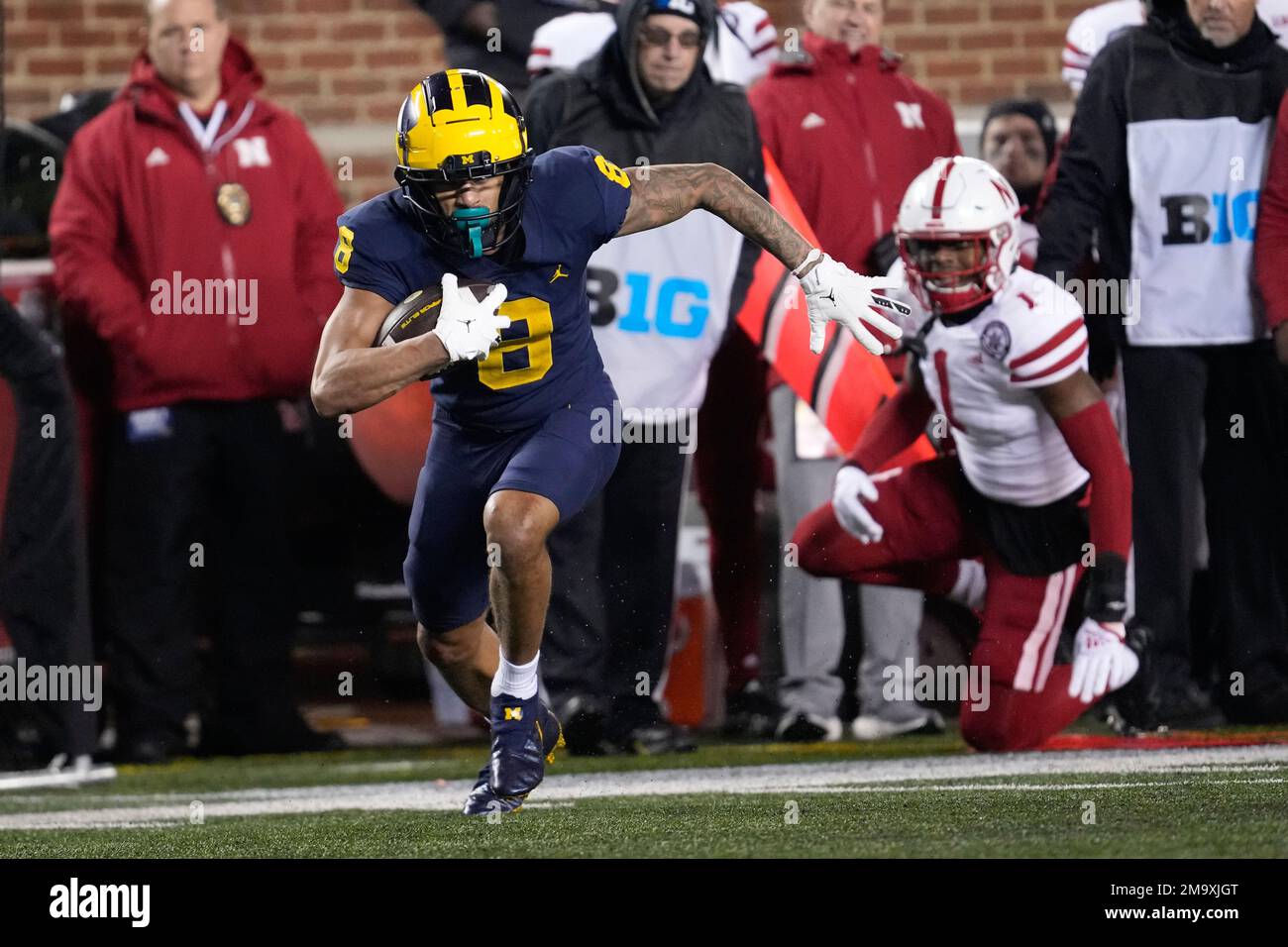Michigan wide receiver Ronnie Bell (8) breaks the tackle of Nebraska ...