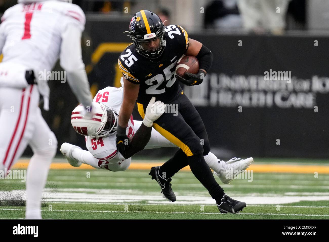 Iowa running back Gavin Williams (25) tries to break a tackle by ...