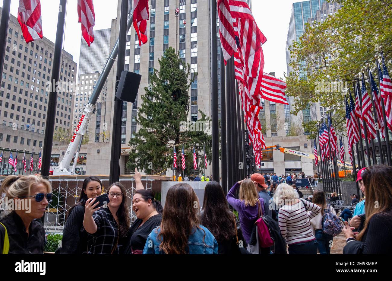 Visitors watch as the 2022 Rockefeller Center Christmas is raised from ...