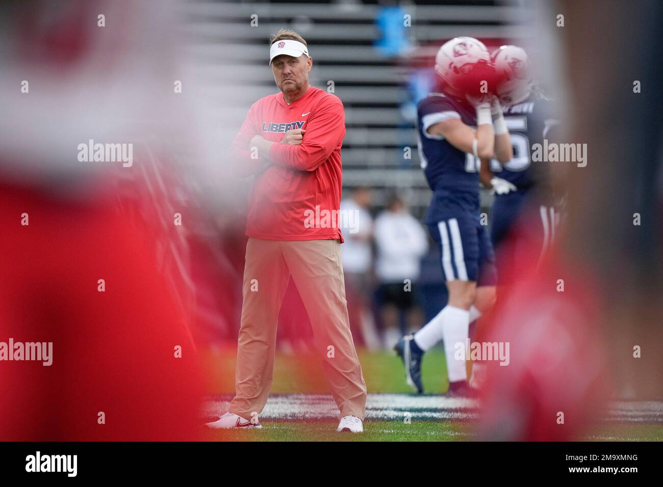 Liberty head coach Hugh Freeze watches as players warm up prior to an ...
