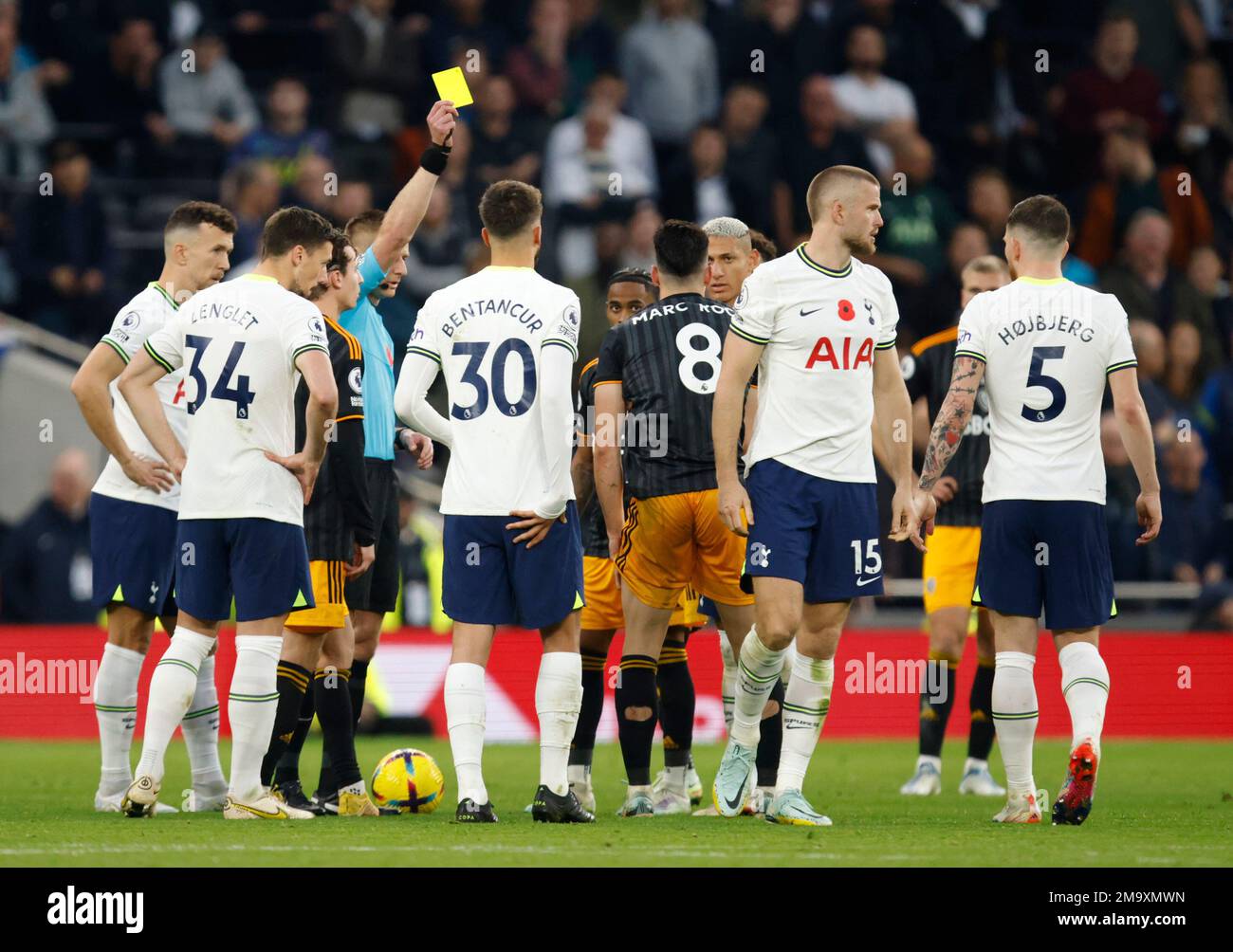 Referee Michael Salisbury shows a yellow card to Leeds United's Marc ...