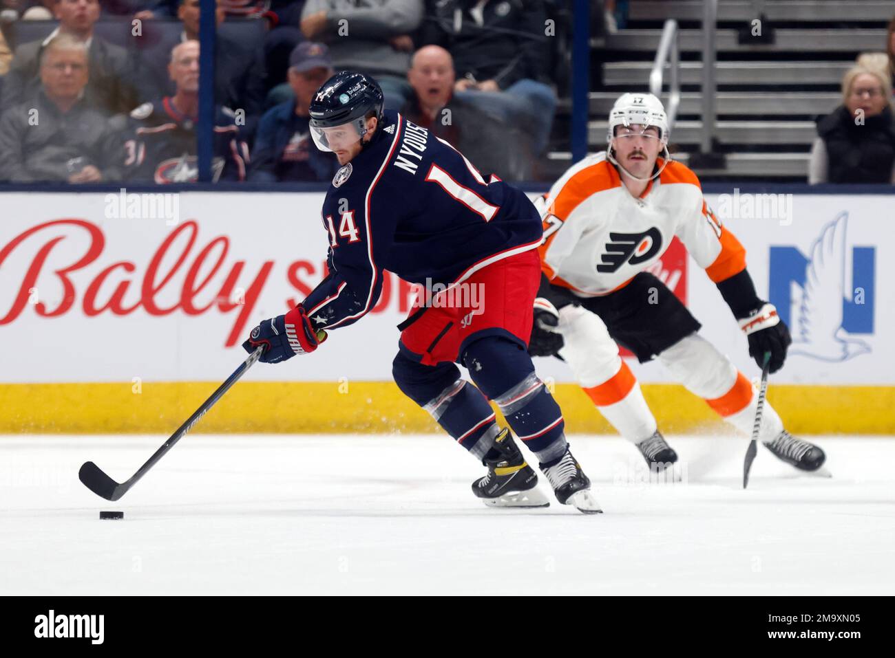 Columbus Blue Jackets forward Gustav Nyquist, left, controls the puck ...
