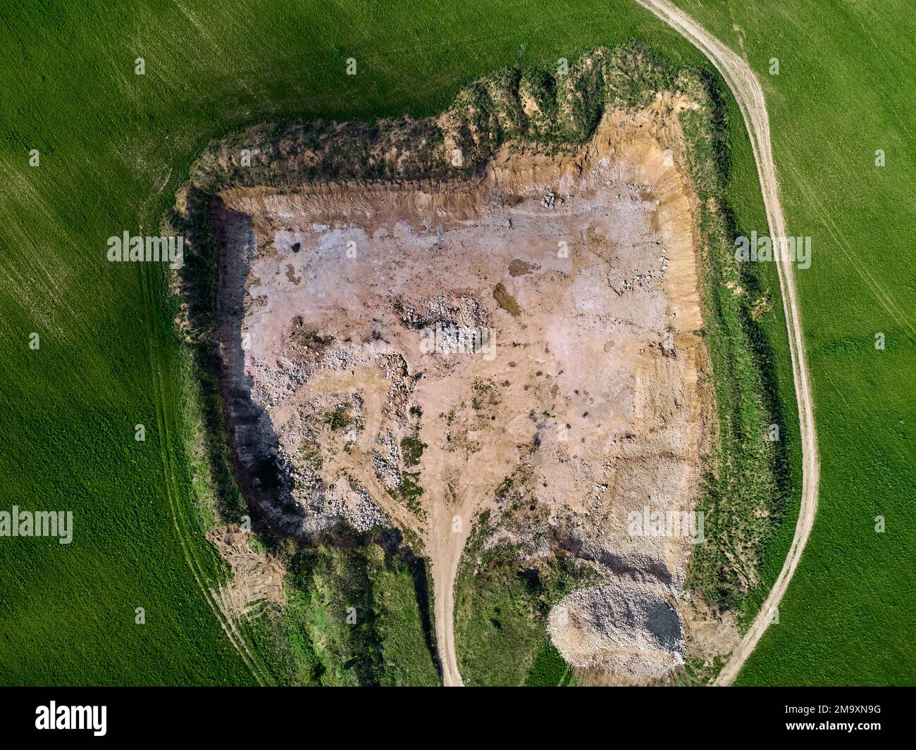 View from a high altitude of a stone quarry dug in the middle of a ...