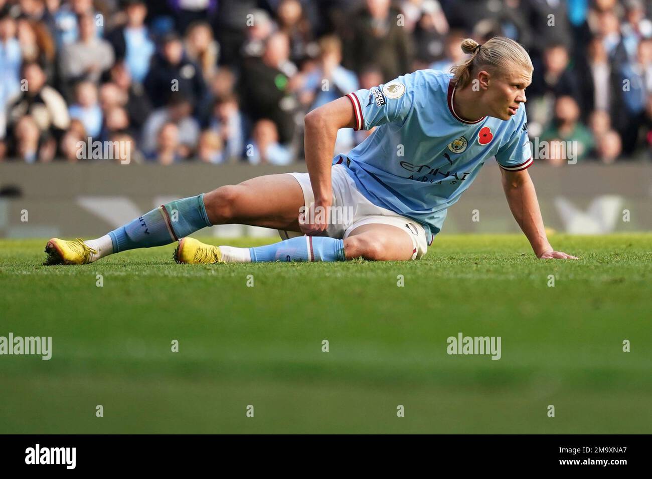 Manchester City's Erling Haaland lies on the ground after missing a ...