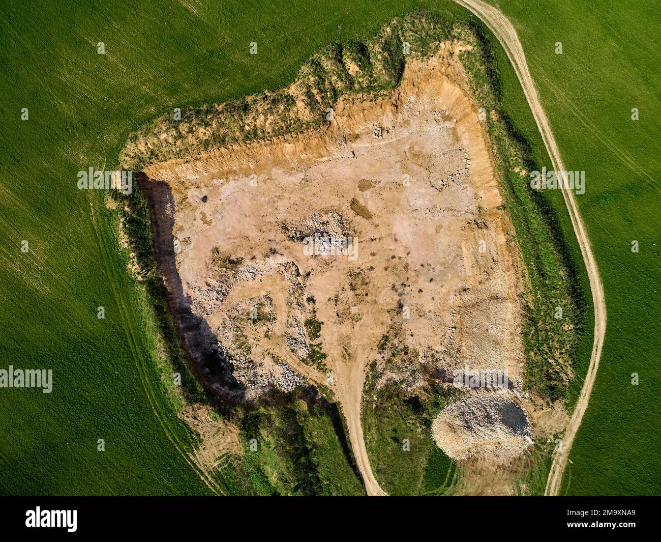 View from a high altitude of a stone quarry dug in the middle of a ...