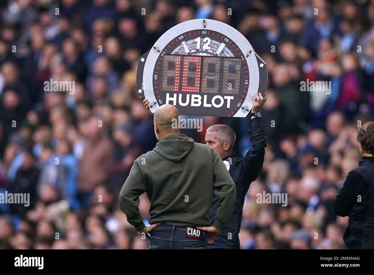Manchester City's head coach Pep Guardiola looks assistant referee ...