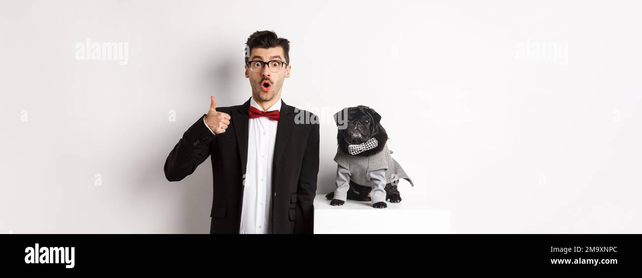 Animals, party and celebration concept. Handsome young man in suit and ...