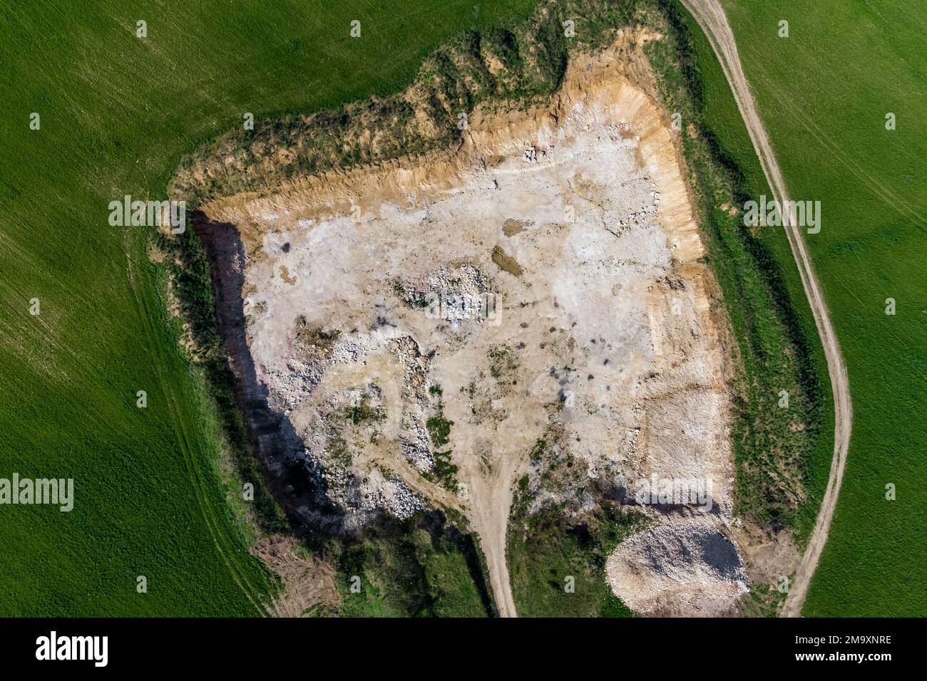 View from a high altitude of a stone quarry dug in the middle of a ...
