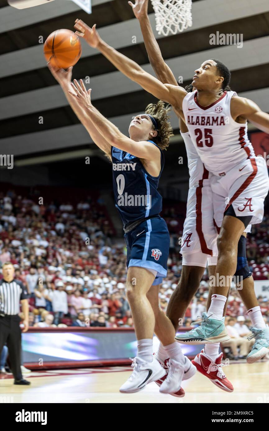 Alabama guard Nimari Burnett (25) goes for a block as Liberty guard ...
