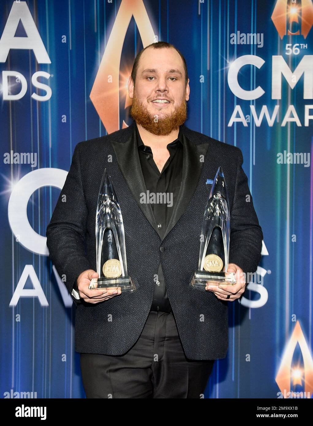 luke-combs-poses-in-the-press-room-with-the-awards-for-album-of-the