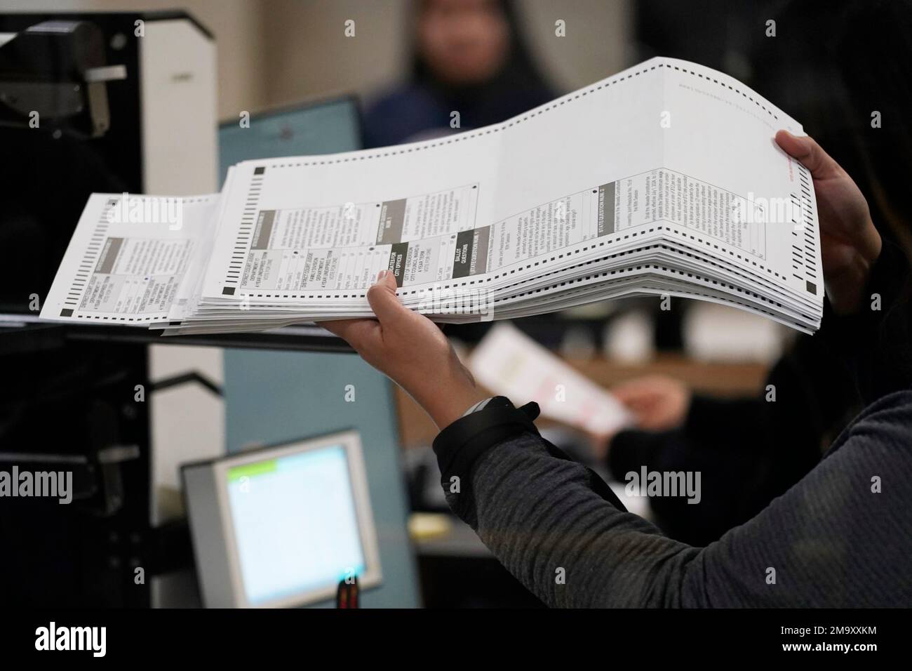 An election worker processes ballots at the Clark County Election ...